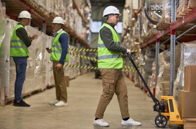 Shot of Three Workers Doing Operations in Storage Warehouse Stock Image ...
