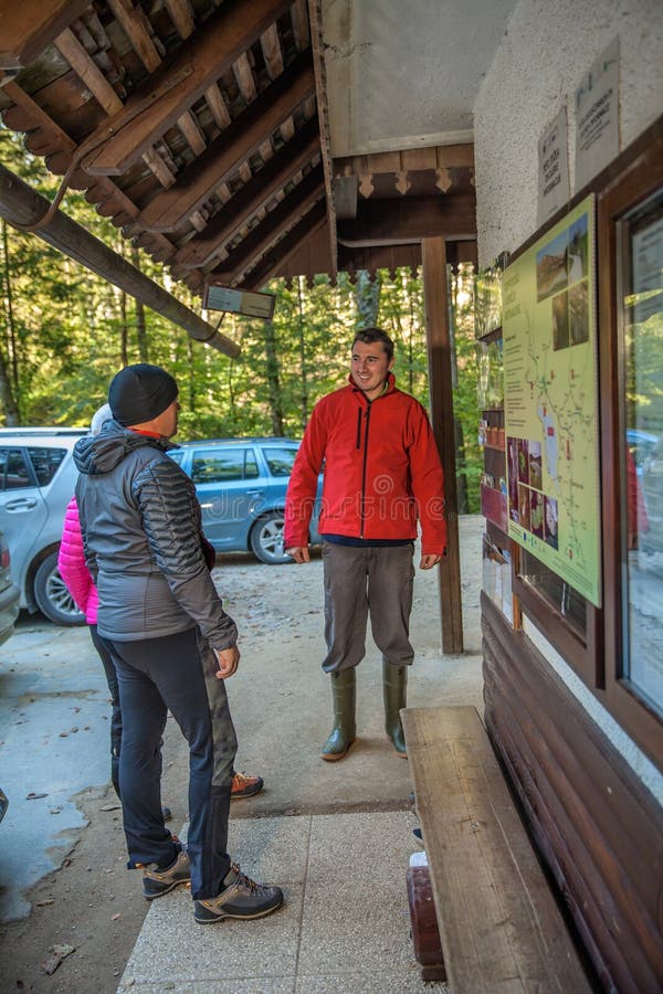 Shot of a Tourist Couple Smiling and Talking To the Tourist Guide ...