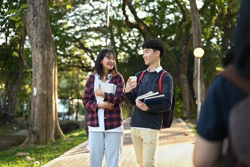 Shot of Two Asian Student Talking To Each Other while Going To Lecture ...