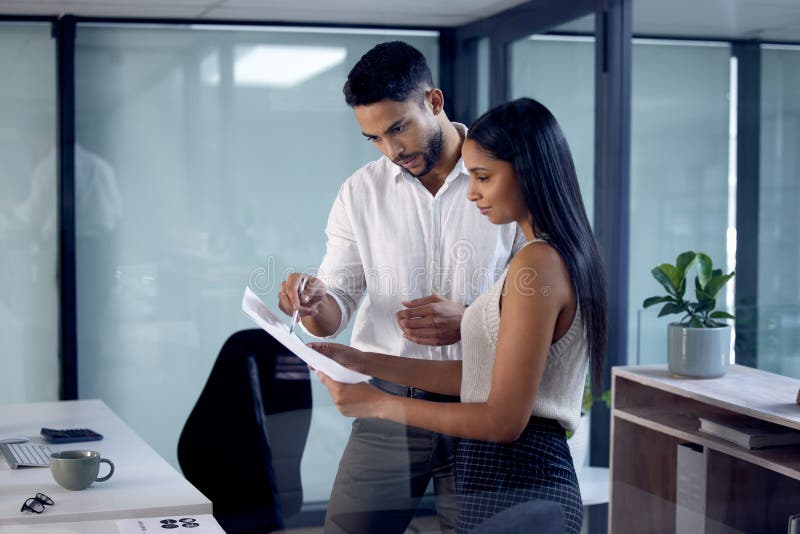 What Do You Think about it. Shot of Two Work Colleagues Reading Over ...