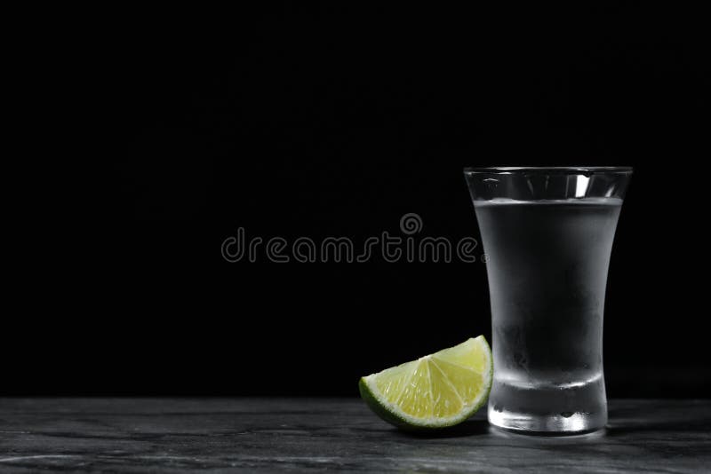 Shot of Vodka with Lime Slice on Grey Table. Space for Text Stock Photo ...