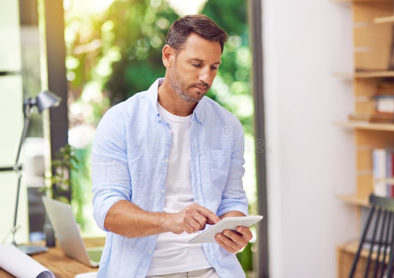 Doing Everything Online. Shot of a Young Man Working from Home. Stock ...