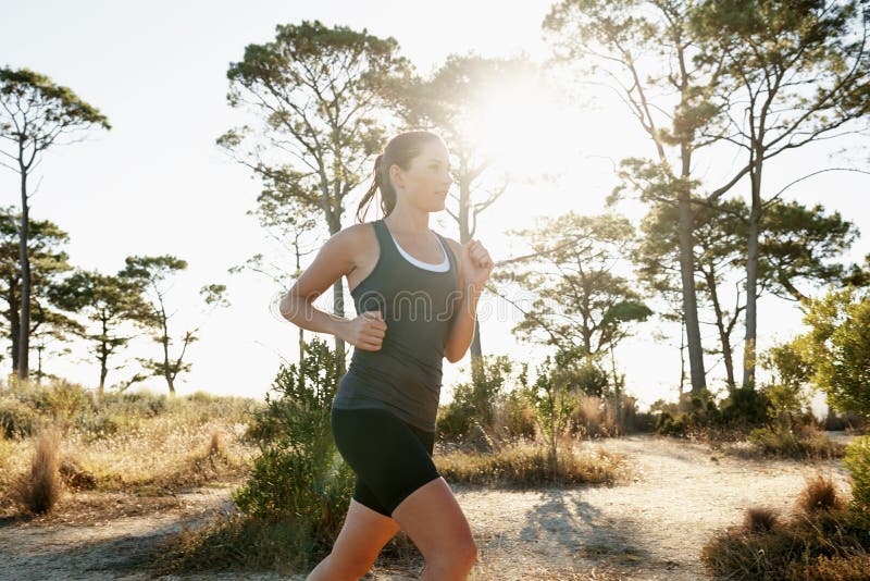 She Loves Trail Running. Shot of a Young Runner Training Outdoors ...
