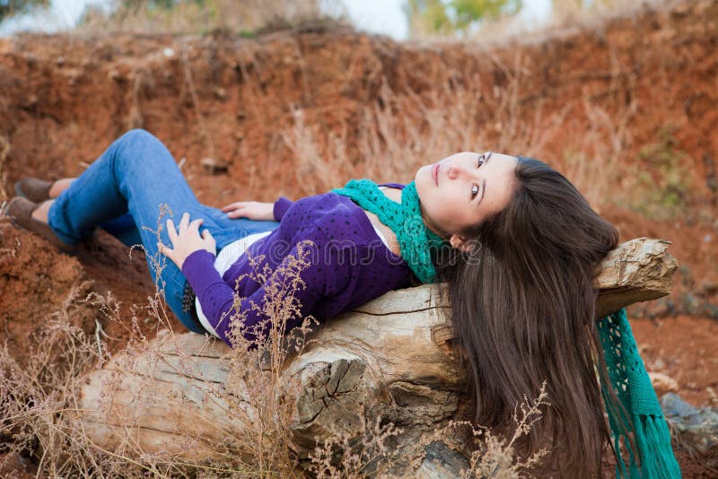 Shot of a Young Woman Lying on Log Stock Photo - Image of girl, cute ...