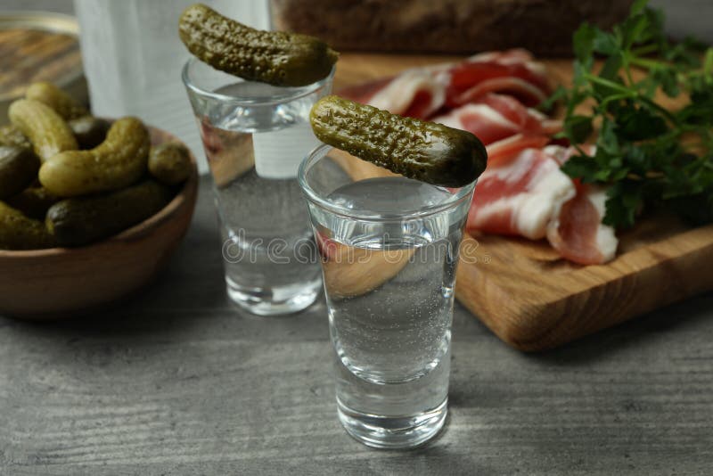 Shots of Vodka and Different Snacks on Gray Background Stock Photo ...
