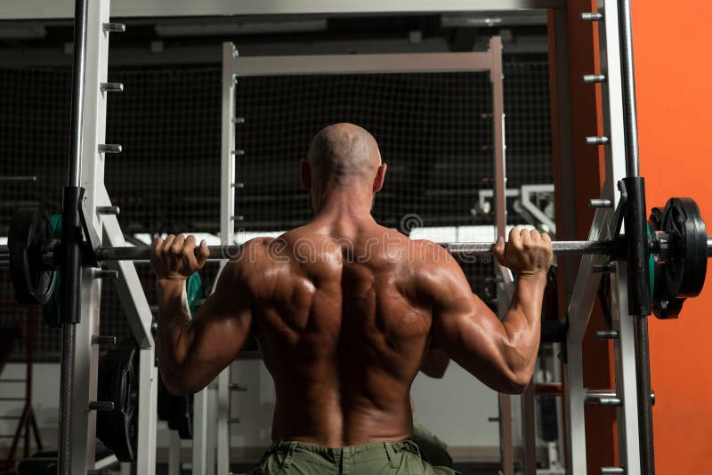 Shoulder Exercises on a Smith Machine Stock Image - Image of equipment ...
