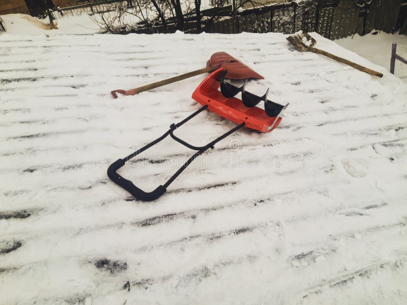 Shovel for Clearing Snow on the Roof of the House Stock Image - Image ...