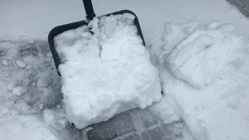 A Shovel Full of Snow in a Backyard. Slow Motion. Close Up. Stock ...