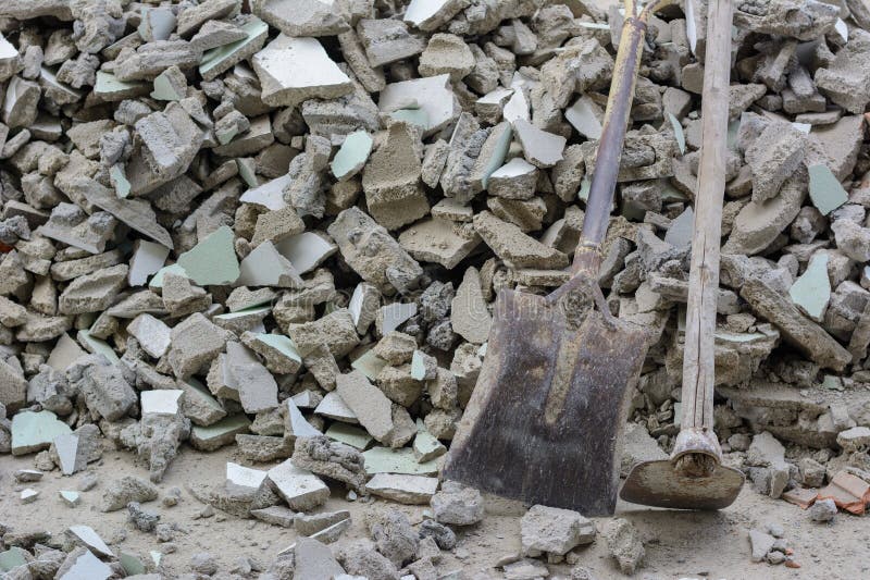 Shovel and Hoe on Concrete Rubble Pile Stock Image - Image of ground ...