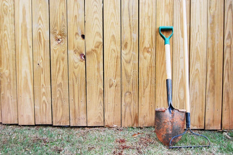 Shovel and Rake on a Fence stock image. Image of work - 7384111