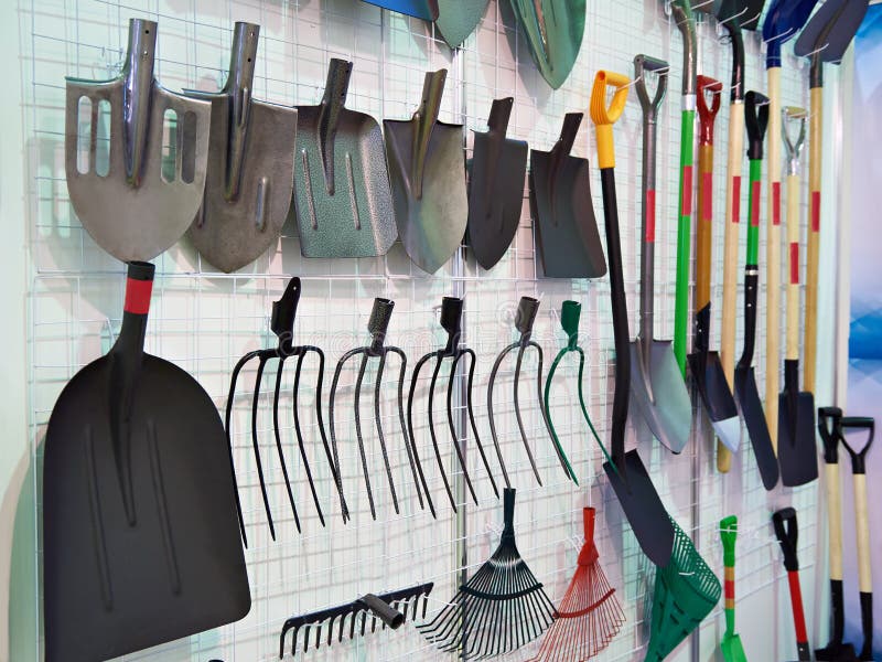 Shovels and forks in store stock image. Image of rack - 103880027