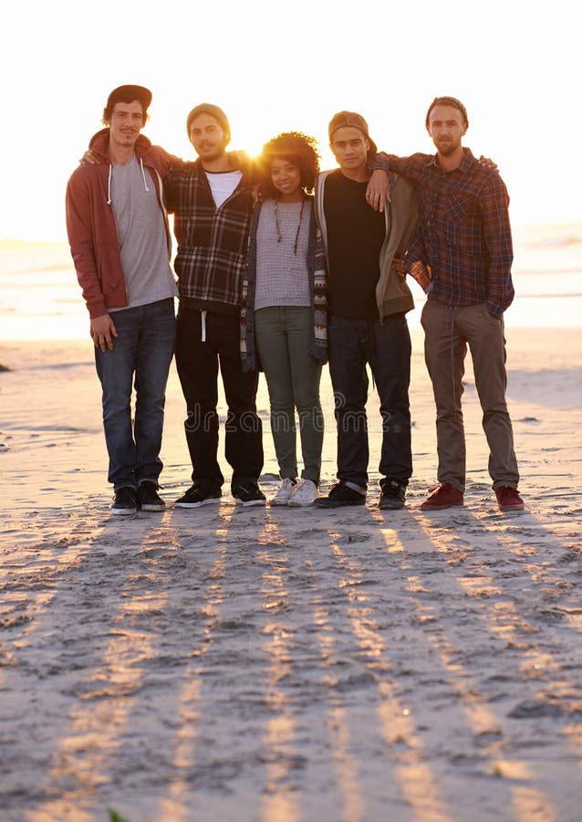 Show Us What You Got. a Group of Friends on a Beach at Sunset. Stock ...