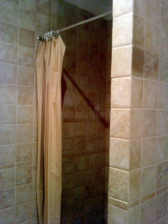 Shower Area with Beige Curtain and Tiled Walls in a Simple Bathroom ...