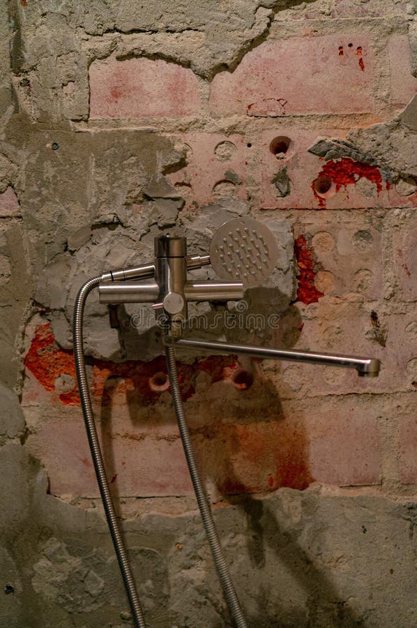 Shower Faucet on a Rough Brick and Plaster Wall Stock Photo - Image of ...