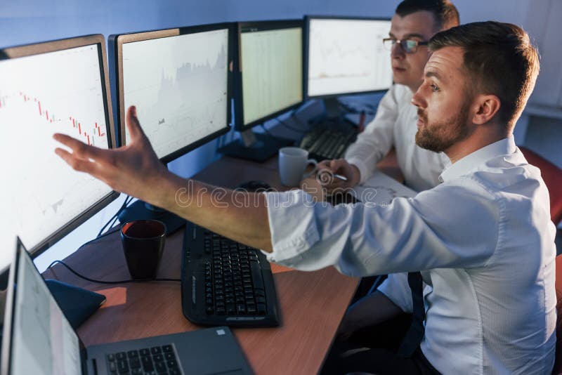 Showing Graph Place. Two Stock Traders Working in the Office with ...