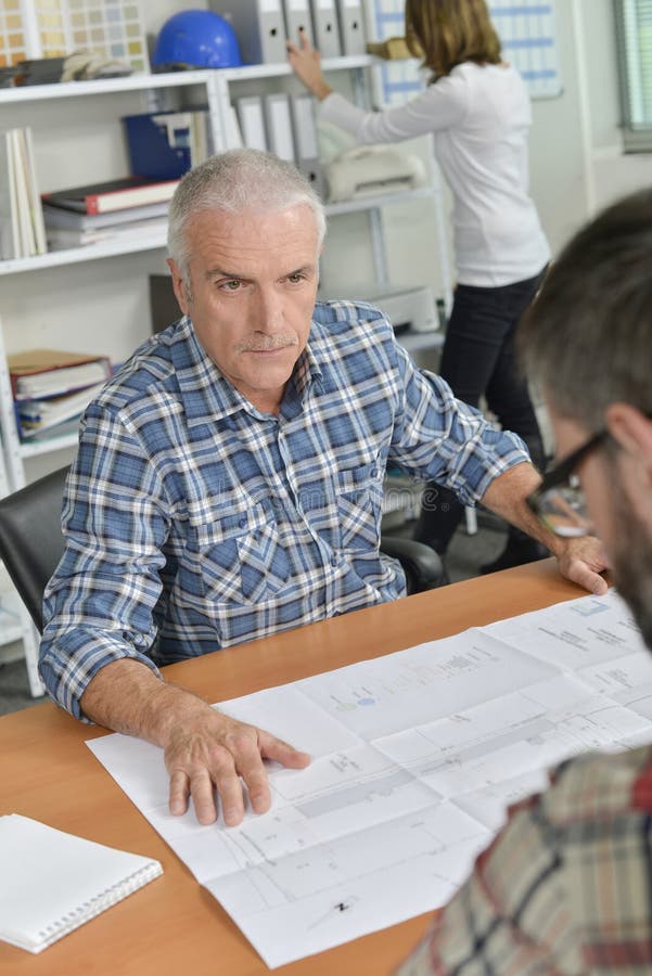 Showing plans to client stock photo. Image of house - 102665516