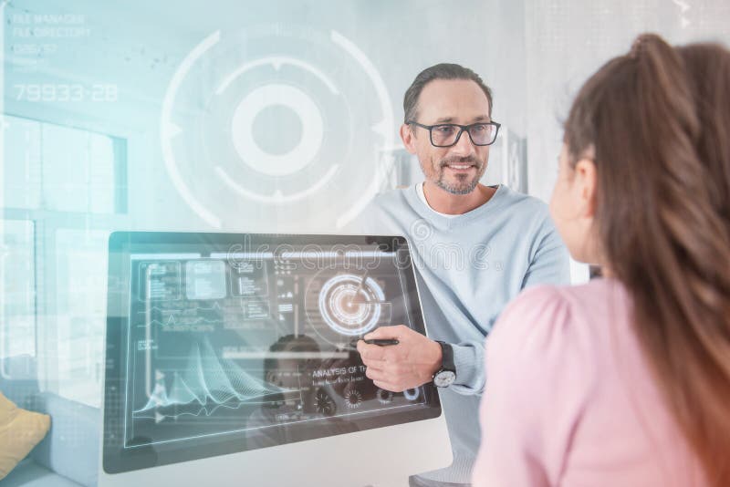 Kind Programmer Smiling while Showing a New Device To His Curious ...