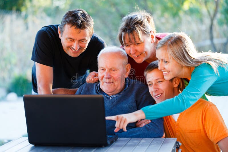Volunteers Teaching a Senior How To Use a Computer Stock Image - Image ...