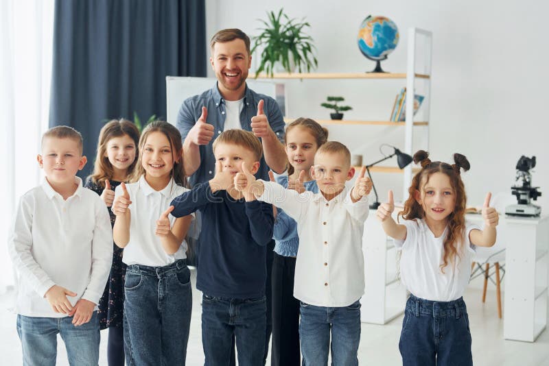 Showing Thumbs Up. Group of Children Students in Class at School with ...