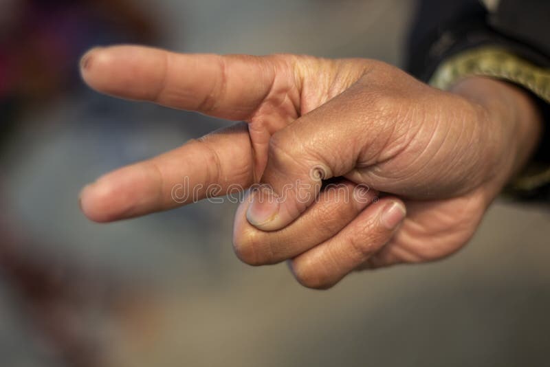 Showing Two Fingers Like Devil Horns and the Background Blur Stock ...