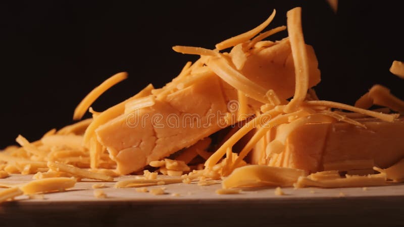 Shredded Cheddar Cheese Falling in Slow Motion. Stock Video - Video of ...