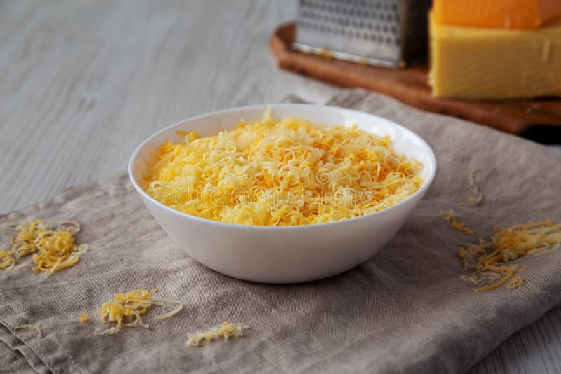 Shredded Mexican Cheese Mix in a White Bowl, Side View Stock Photo ...