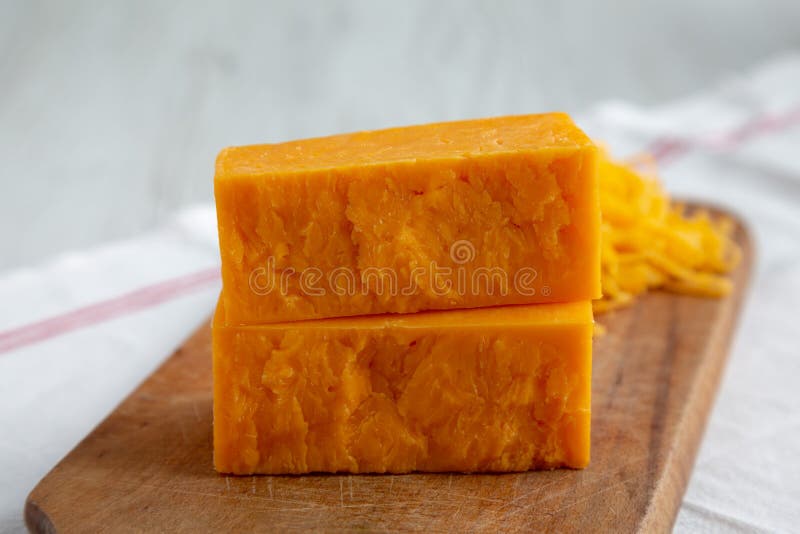 Shredded Sharp Cheddar Cheese on a Rustic Wooden Board, Side View ...