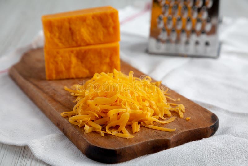 Shredded Sharp Cheddar Cheese on a Rustic Wooden Board, Side View ...