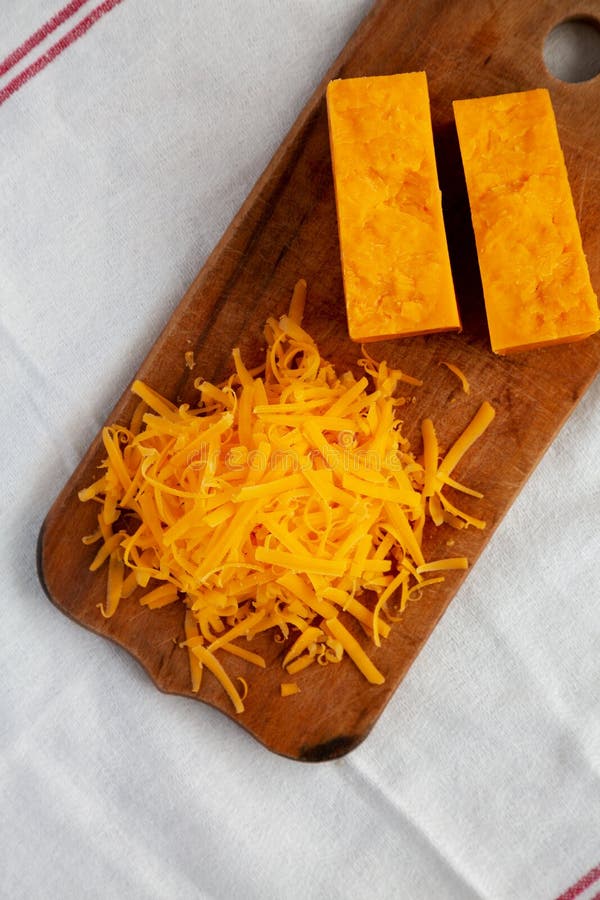Shredded Sharp Cheddar Cheese on a Rustic Wooden Board, Top View. Flat ...