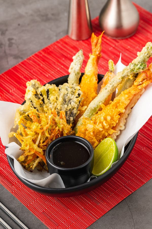 Shrimp Tempura with Vegetable Tempura on a Black Ceramic Plate Stock ...
