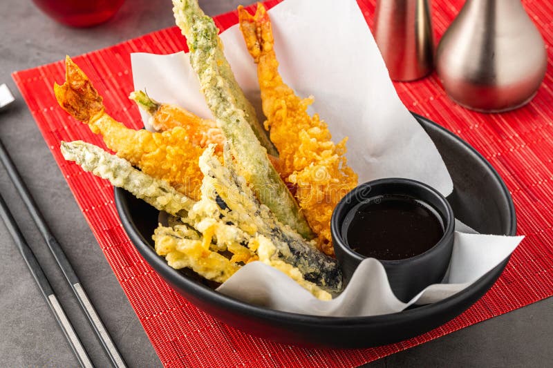 Shrimp Tempura with Vegetable Tempura on a Black Ceramic Plate Stock ...