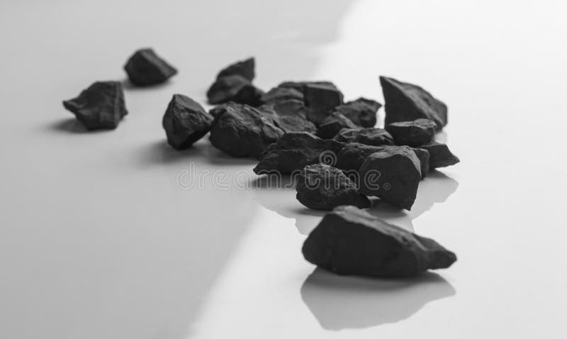 Shungite Stones on a White Background with Shadows with a Copy of the ...