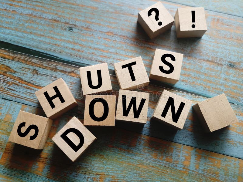 SHUTS DOWN Word at Cubes Block Over Blue Wooden Background. Stock Image ...
