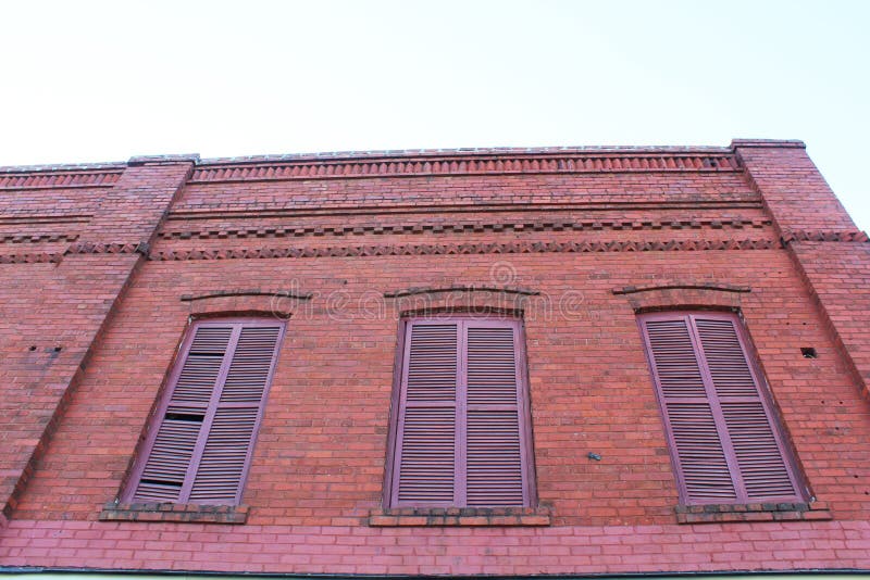 Shuttered Windows of an Old Brick Building Stock Photo - Image of ...