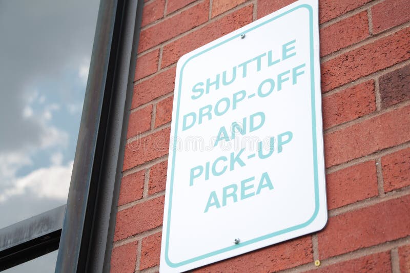 Shuttle Drop Off and Pick Up Area Rectangle Vertical Sign on Red Brick ...
