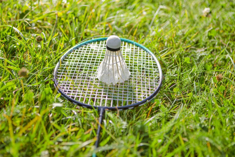 Shuttlecock Along with Carbon Badminton Racket Placed Straight on Lawn ...