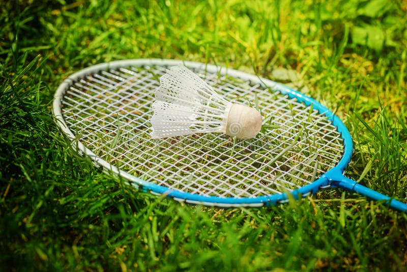 Shuttlecock and Badminton Racket on Green Grass. Stock Image - Image of ...