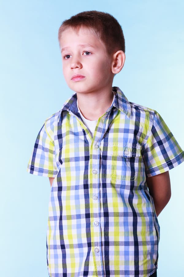 Shy Little Boy with Hands Behind Back. Stock Photo - Image of lonely ...