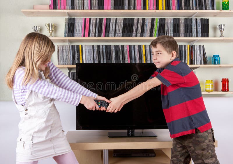 Siblings Arguing Over the Remote Control in the Living Room in F Stock ...