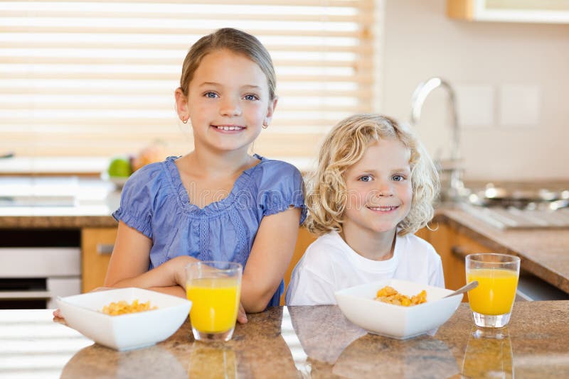 Siblings with Breakfast Behind the Kitchen Counter Stock Photo - Image ...