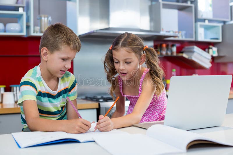 Siblings Doing Homework in Kitchen Stock Image - Image of laptop, house ...