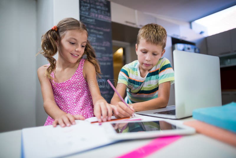 Siblings Doing Their Homework in Kitchen Stock Photo - Image of ...