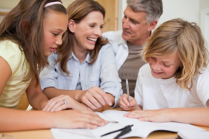 Siblings Getting Help with Homework from Parents Stock Image - Image of ...
