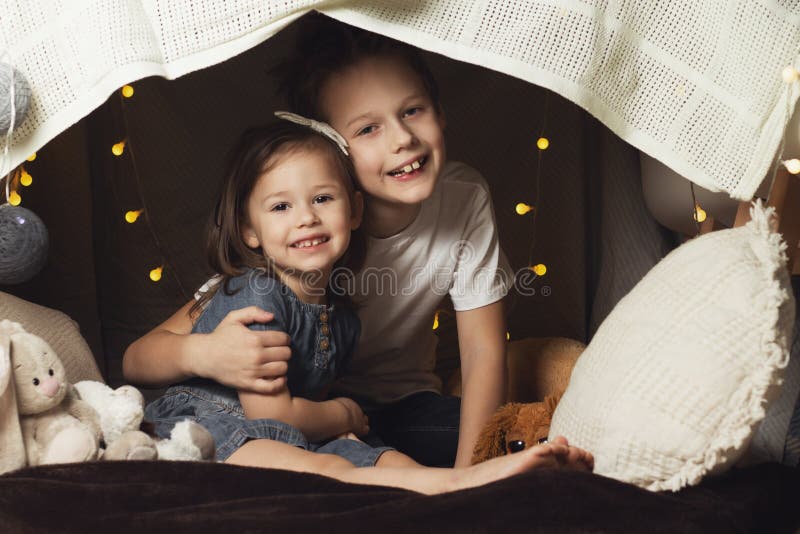 Siblings In A Hut Of Chairs And Blankets Brother And Sister Laugh And