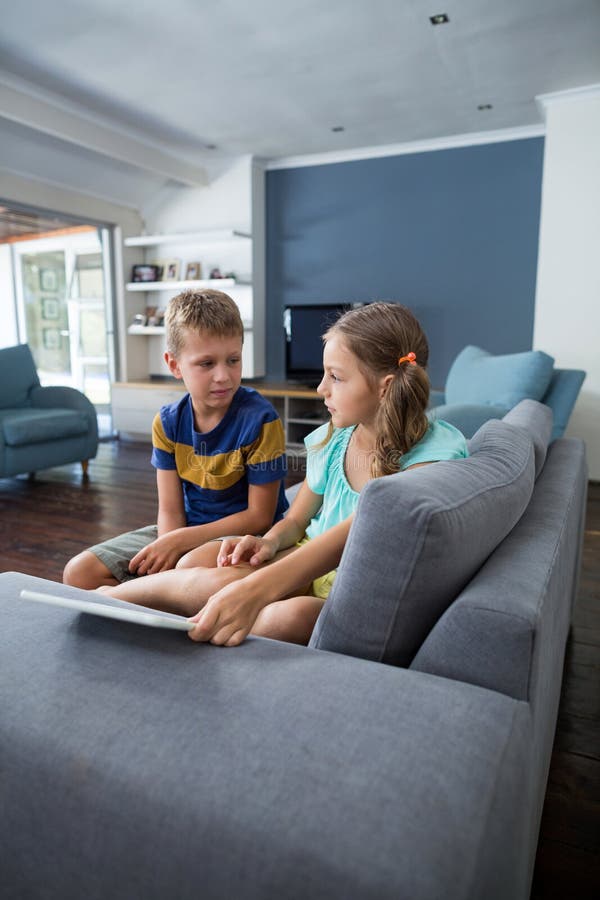 Siblings Interacting with Each Other in Living Room Stock Photo - Image ...