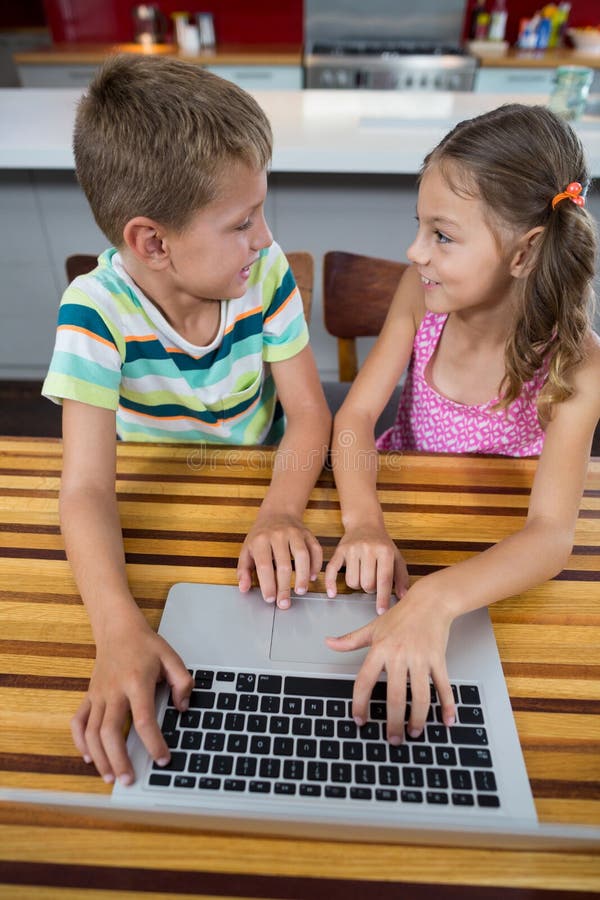 Siblings Interacting with Each Other while Using Laptop Stock Image ...