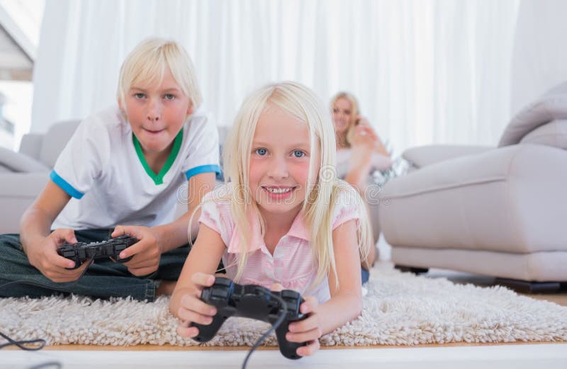 Siblings Playing Video Games Stock Image - Image of cheerful, homey ...