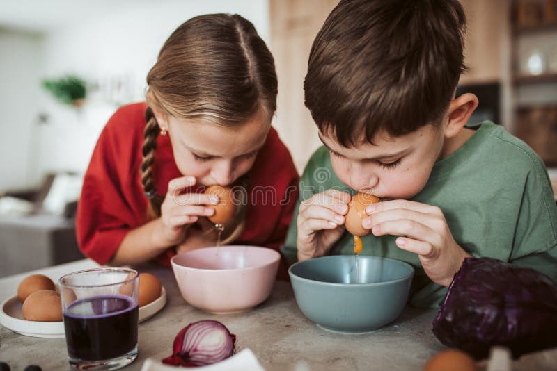 Siblings Preparing Egshells for Easter Egg Decorating. Stock Photo ...
