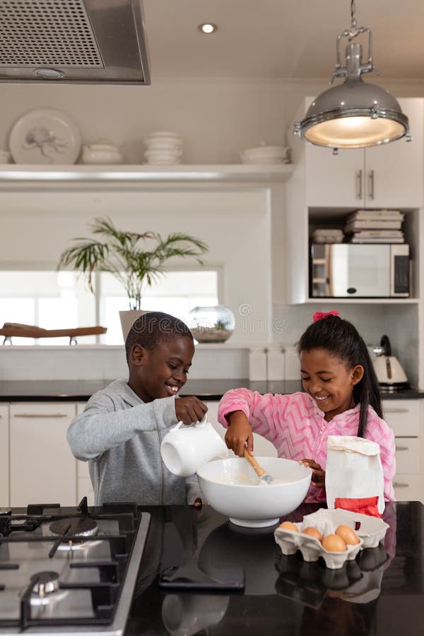 Siblings Preparing Food on a Worktop in Kitchen at Home Stock Image ...