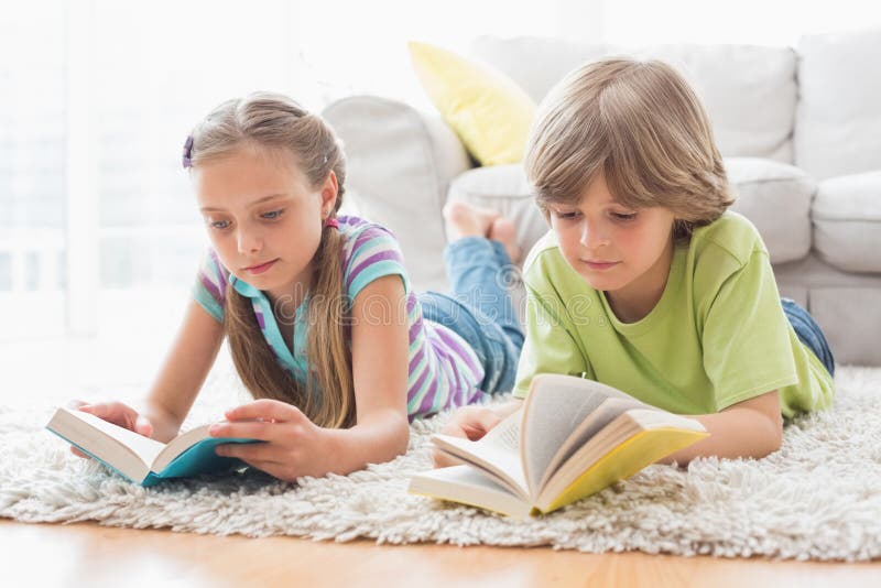 Siblings Reading Books while Lying on Rug Stock Image - Image of room ...